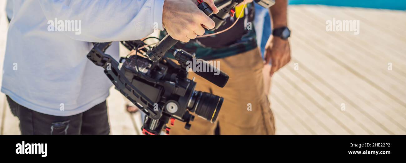 Professional steadicam operator uses a 3-axis camera stabilizer system ...