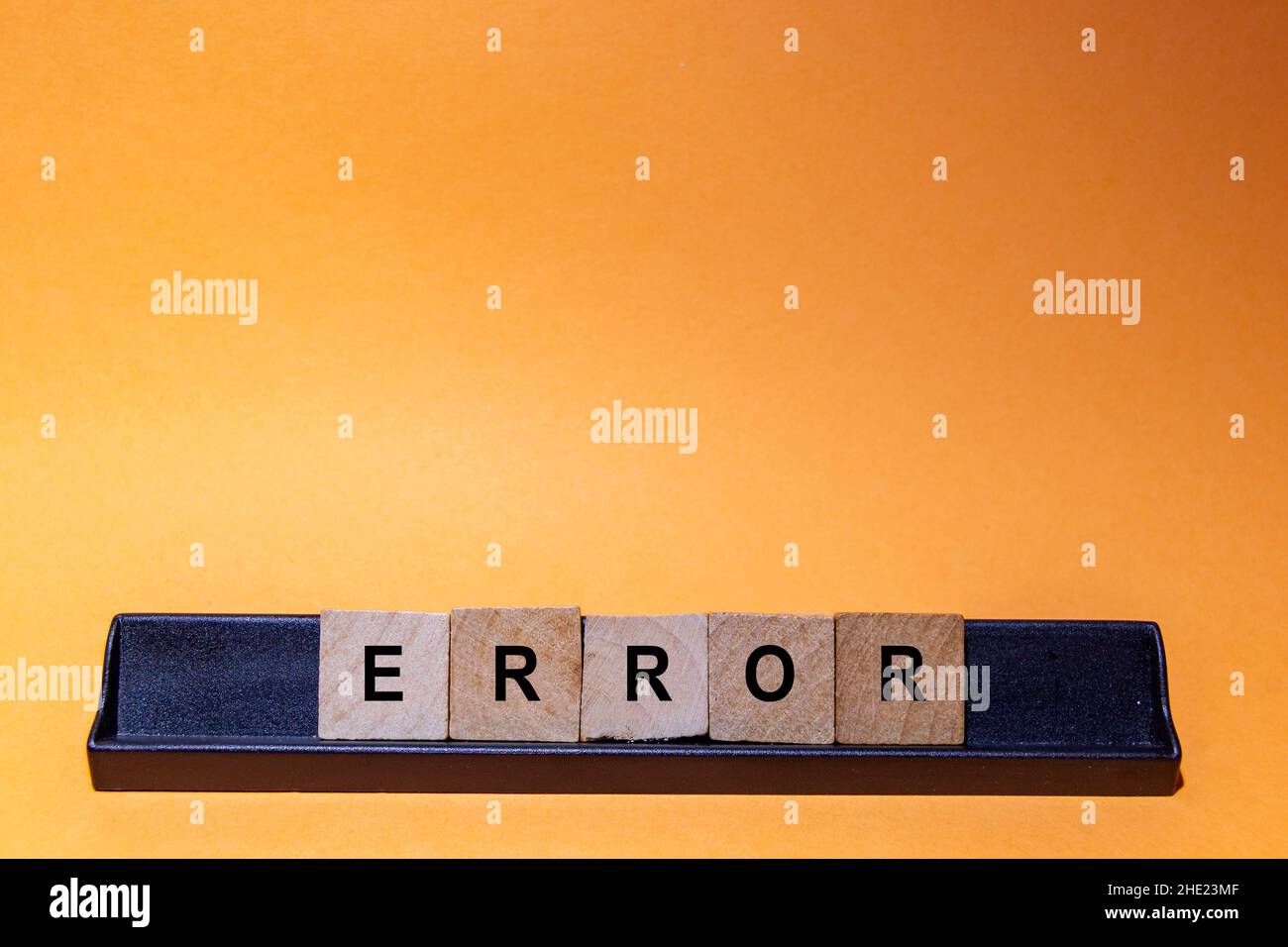 ERROR. Word written on square wooden tiles with an orange background ...
