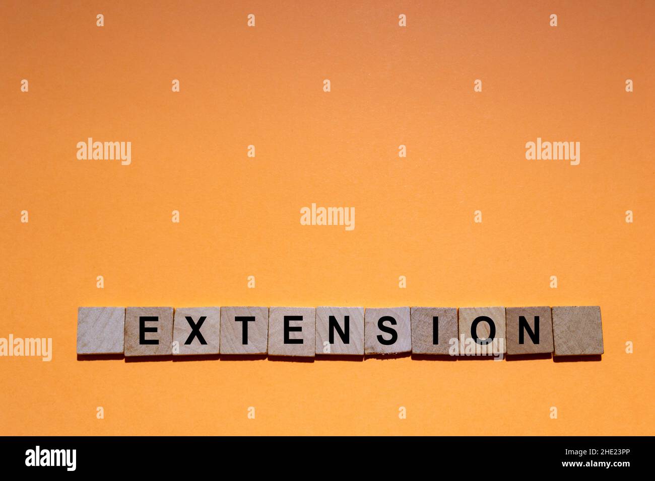 EXTENSION Word Written On Square Wooden Tiles With An Orange extension-word-written-on-square-wooden-tiles-with-an-orange