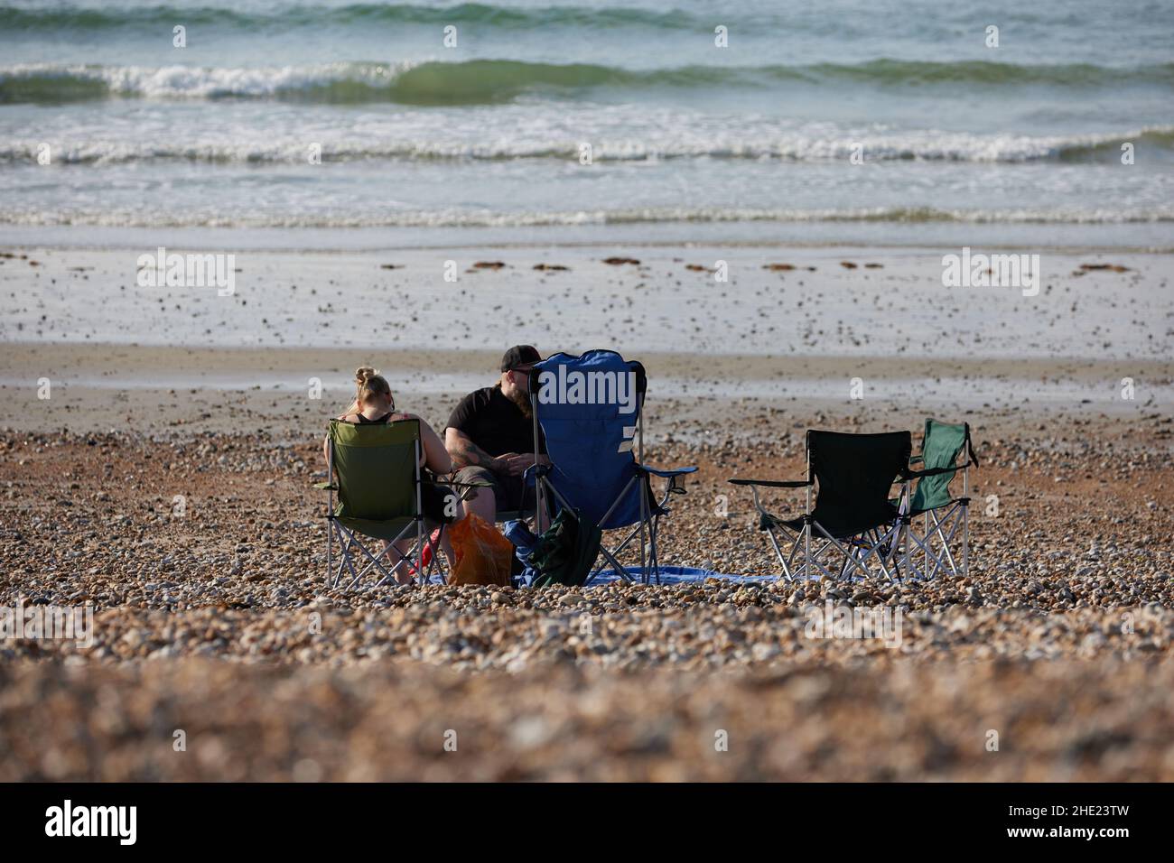 People seen sitting on the beachfront of Bognor Regis Stock Photo - Alamy