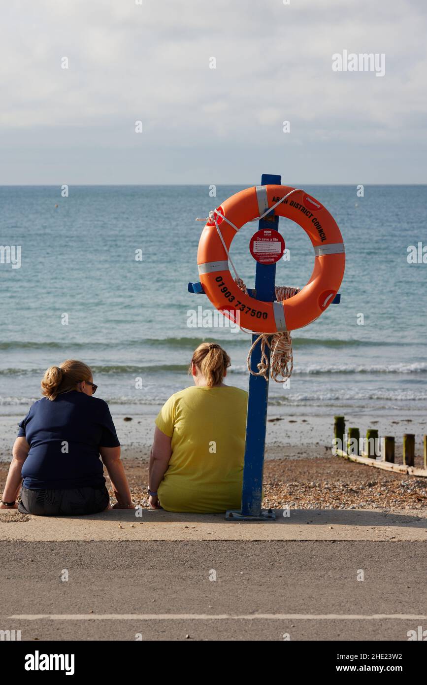 People seen sitting on the beachfront of Bognor Regis Stock Photo - Alamy