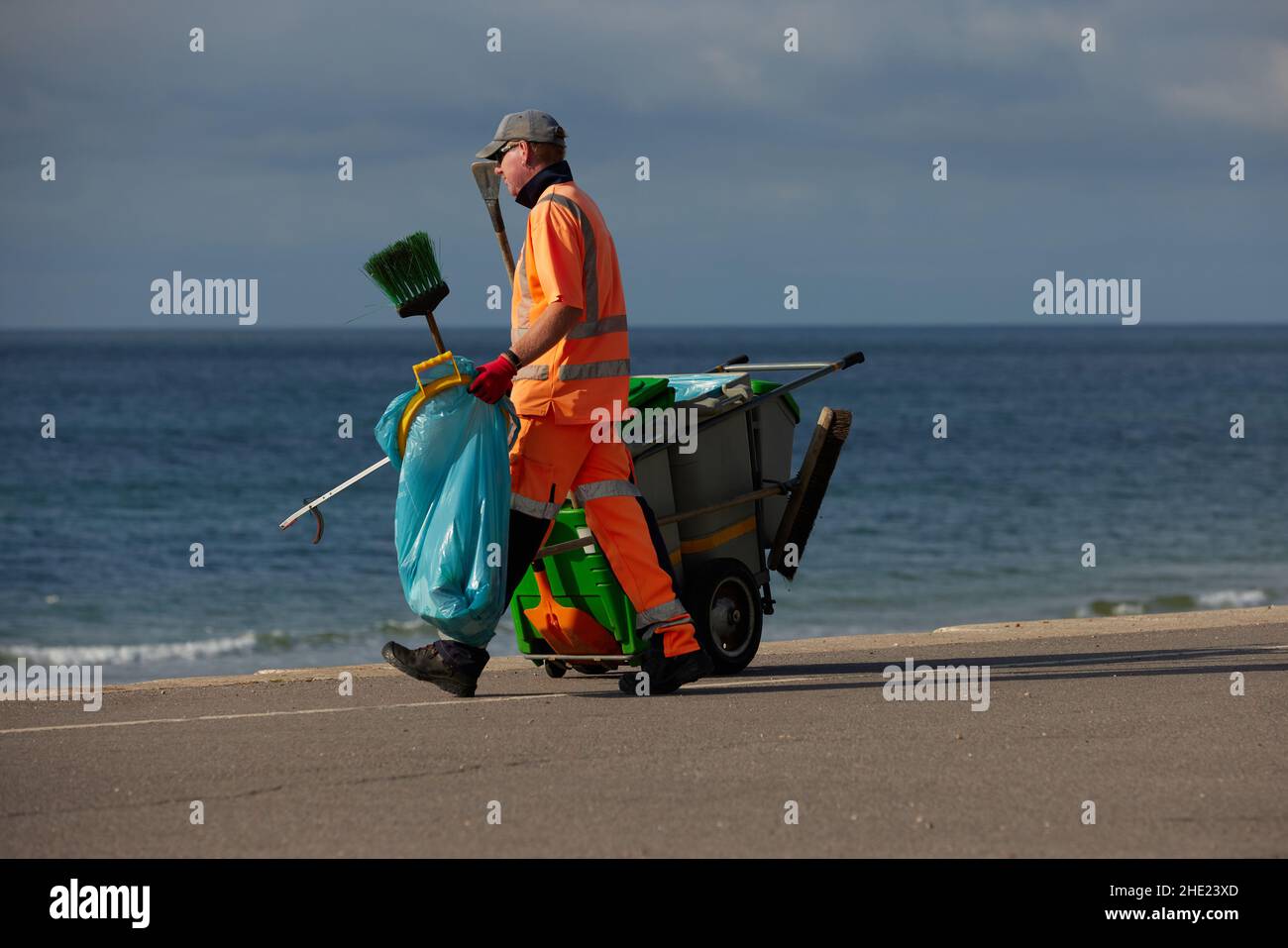 Man seen cleaning the beach as his work Stock Photo - Alamy