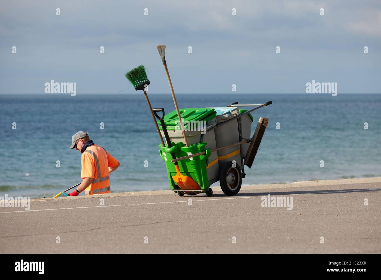 Man seen cleaning the beach as his work Stock Photo - Alamy