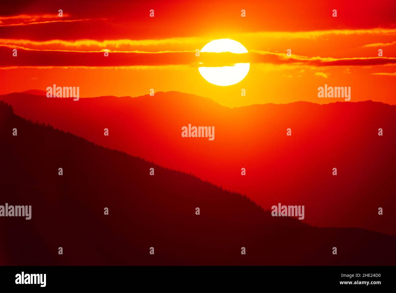 sunset over mountains Stock Photo - Alamy