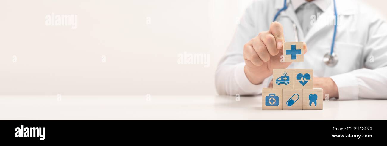 Doctor hand choose cross sign on wood cube block. healthcare medical ...