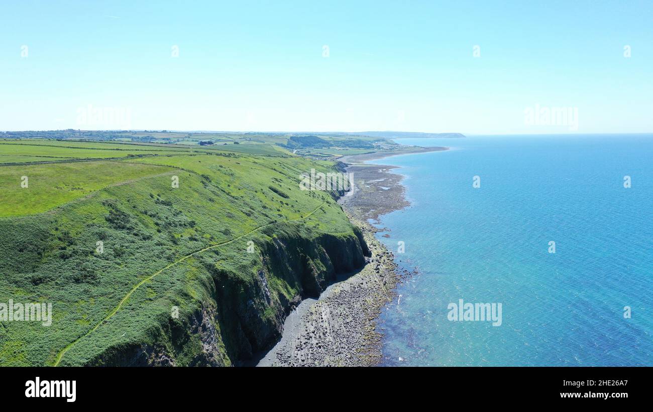 Aerial image of the Welsh coast and cliff in Llannon, Ceredigion. Blue ...