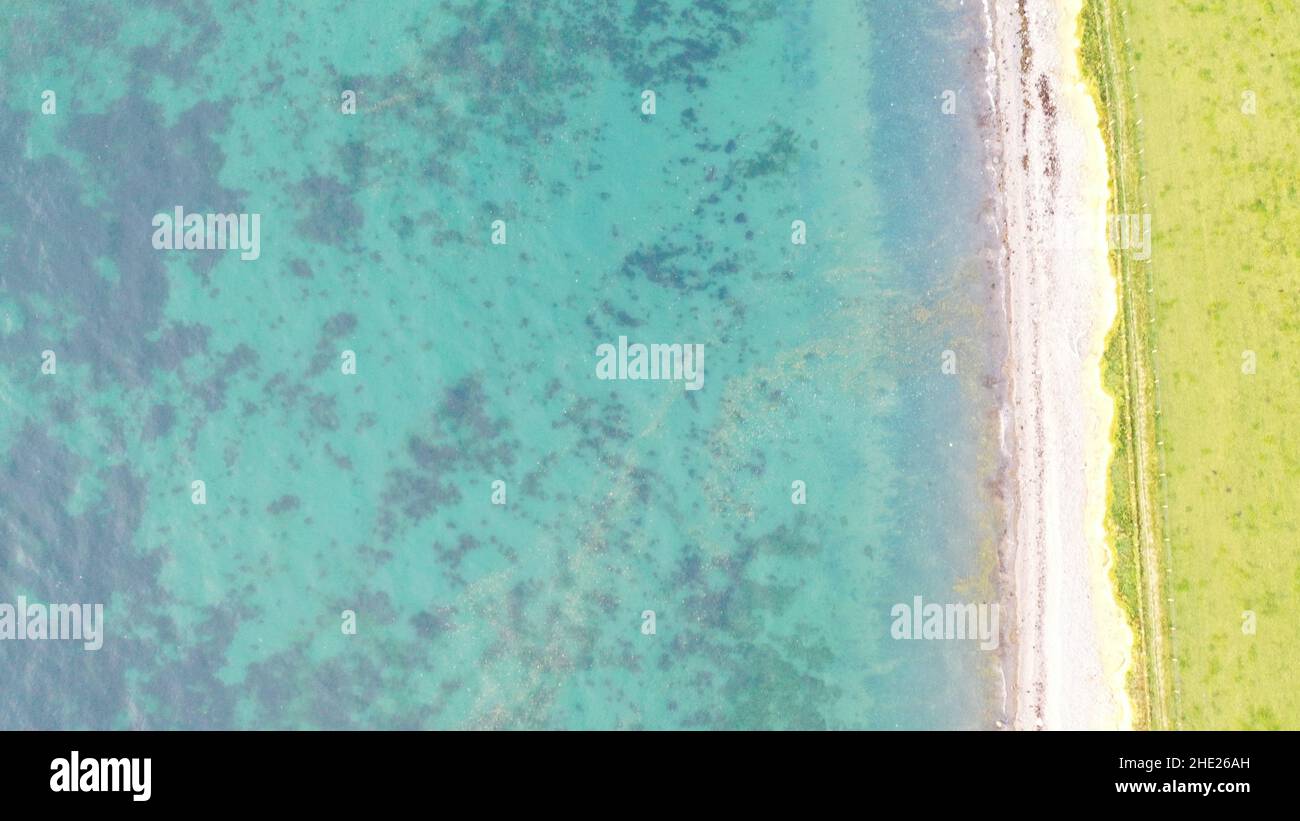 Aerial image of the clear sea, beach and coastal path. Llanon on the ...