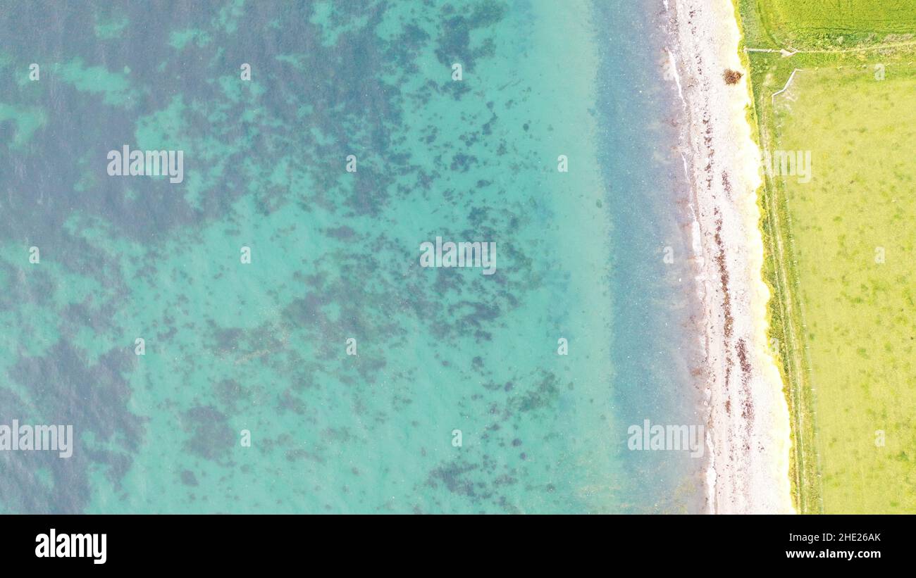 Aerial image of the clear sea, beach and coastal path. Llanon on the ...