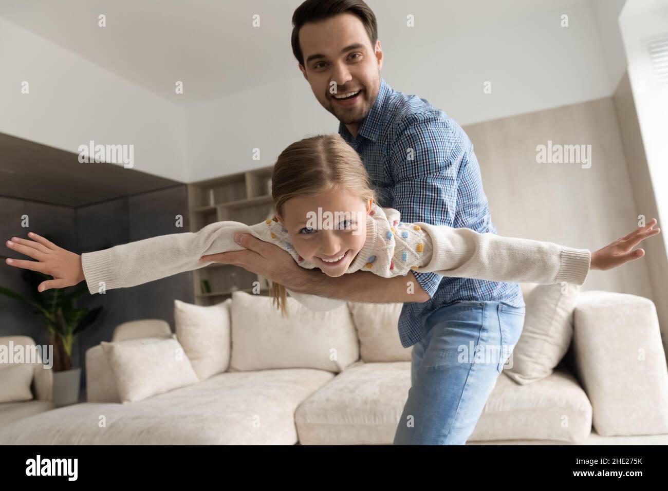Happy caring young dad having fun with joyful daughter Stock Photo - Alamy