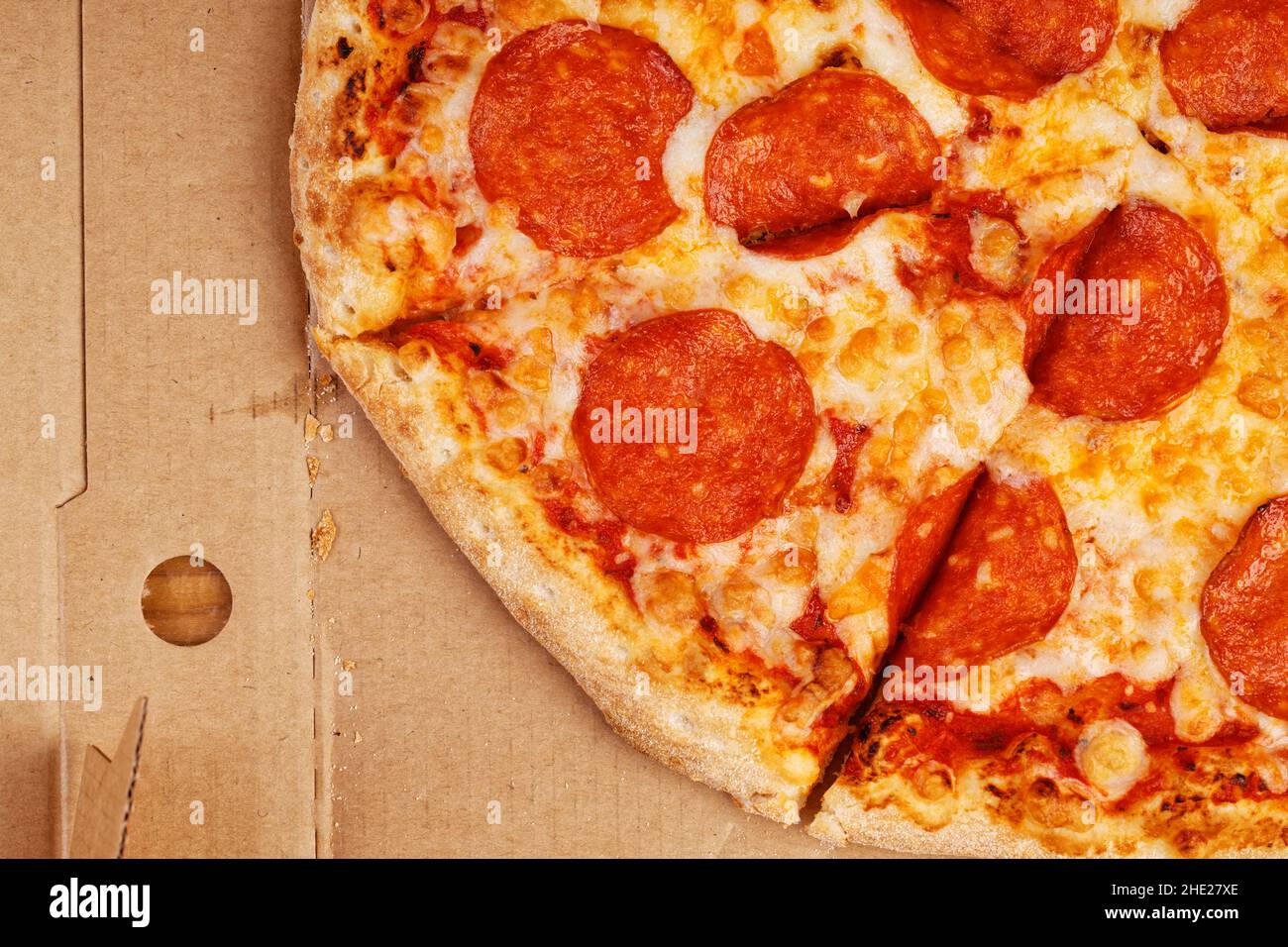 Closeup open box with pepperoni pizza. Top view Stock Photo - Alamy
