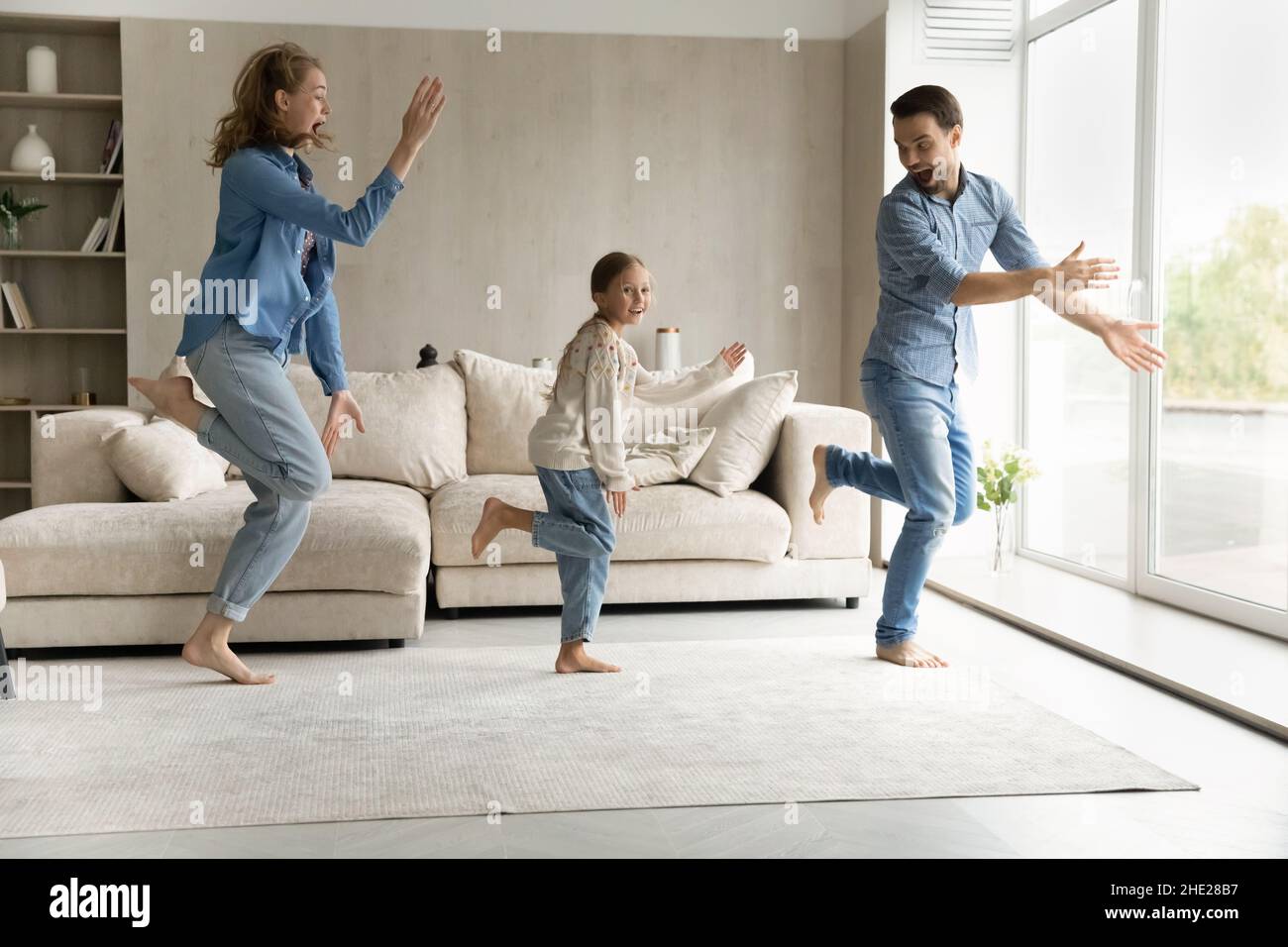 Happy two generations family dancing to music at home Stock Photo - Alamy