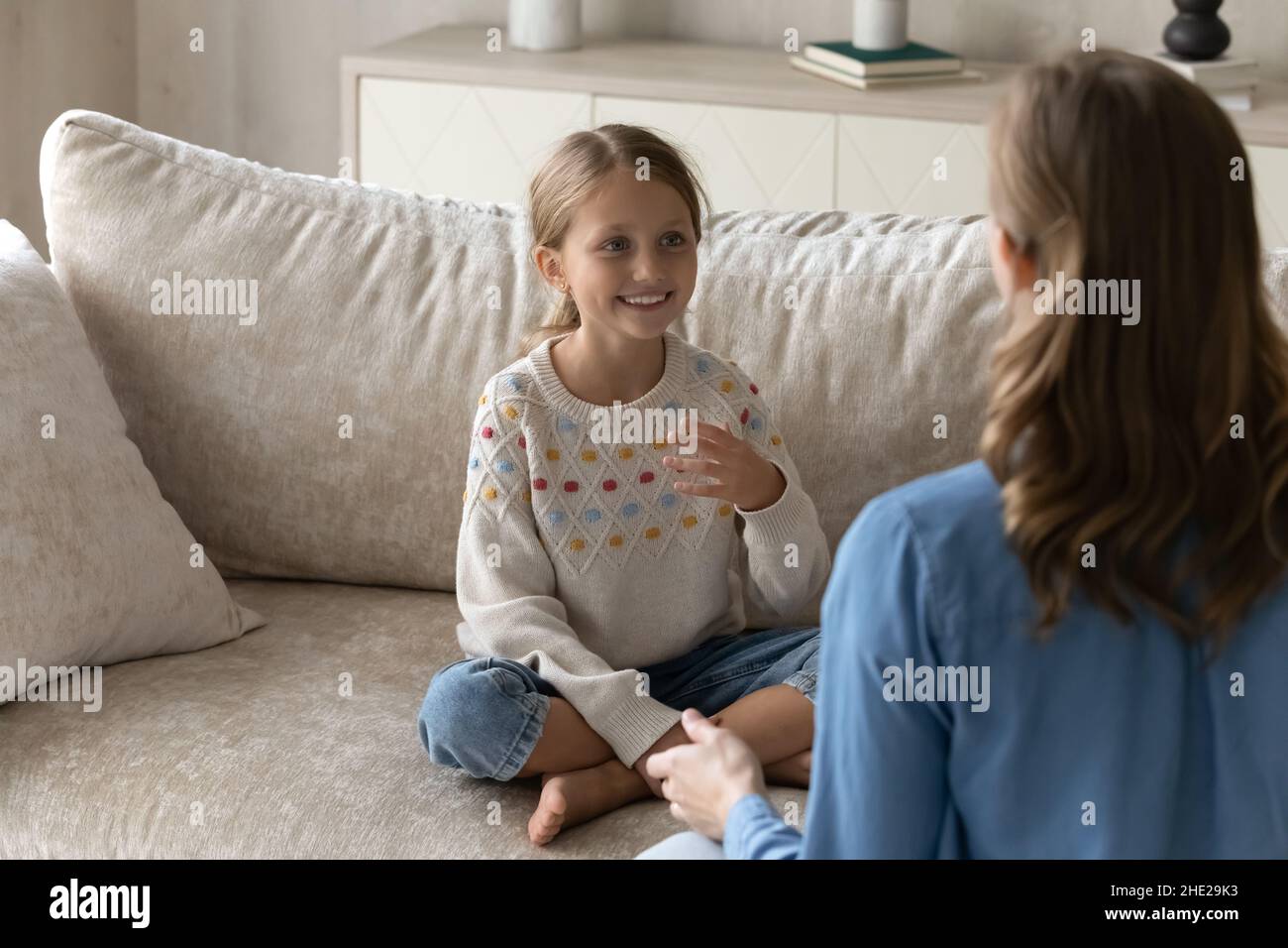 Happy little kid girl doing vocal exercises with mum Stock Photo - Alamy