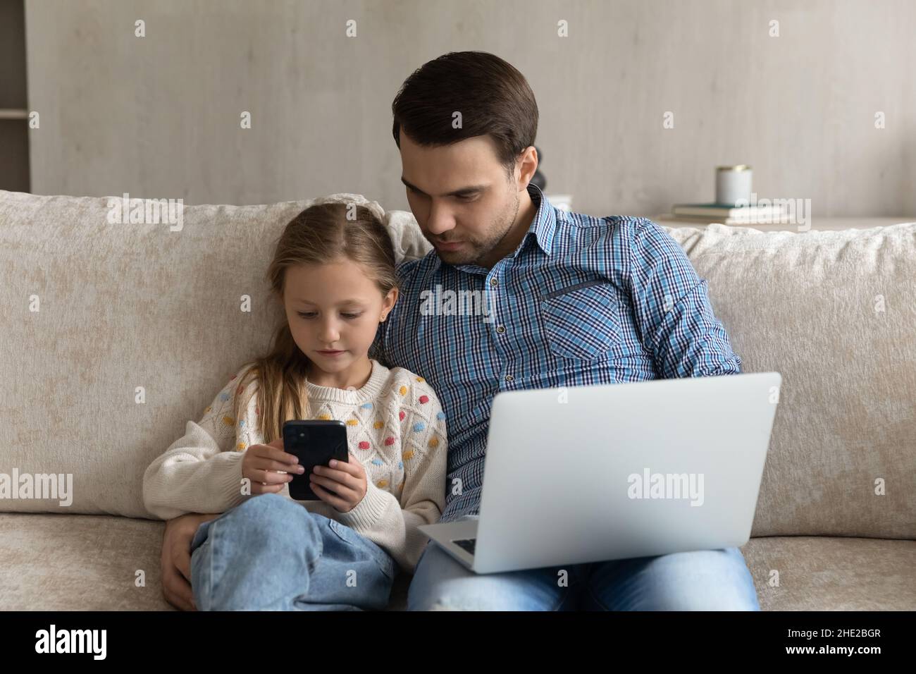 Family using different technology hi-res stock photography and images ...