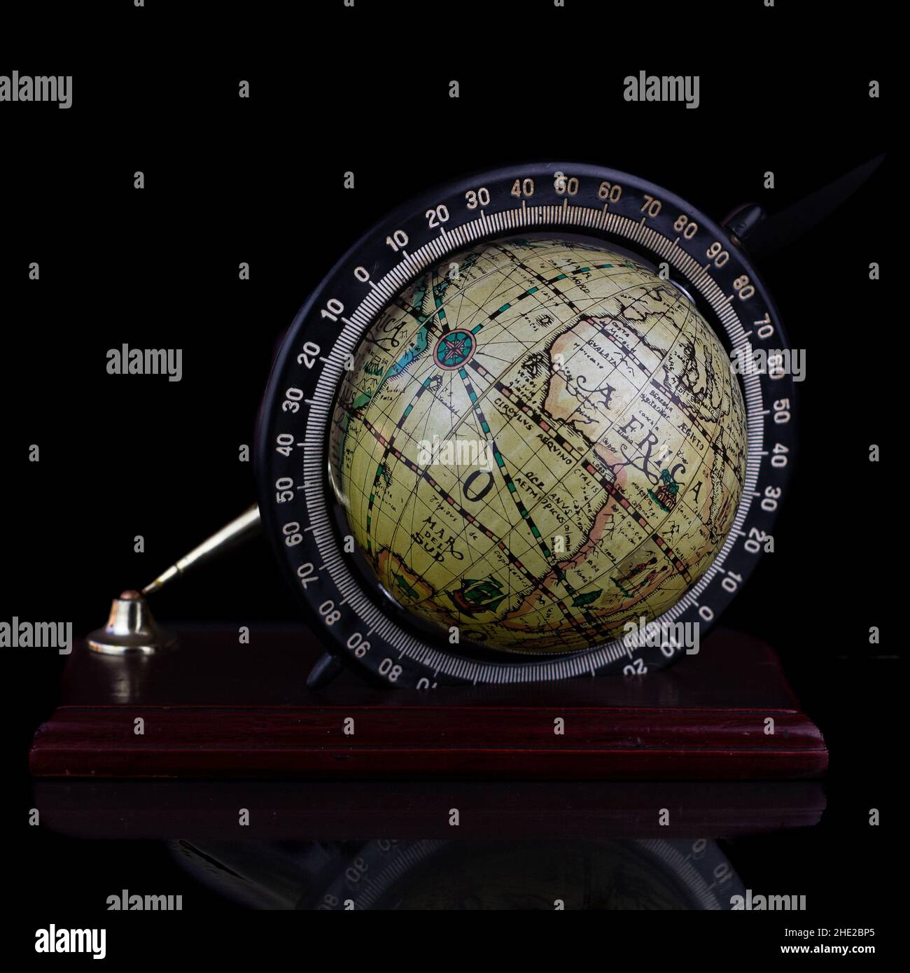 A closeup of a small globe on a table with a black background Stock ...