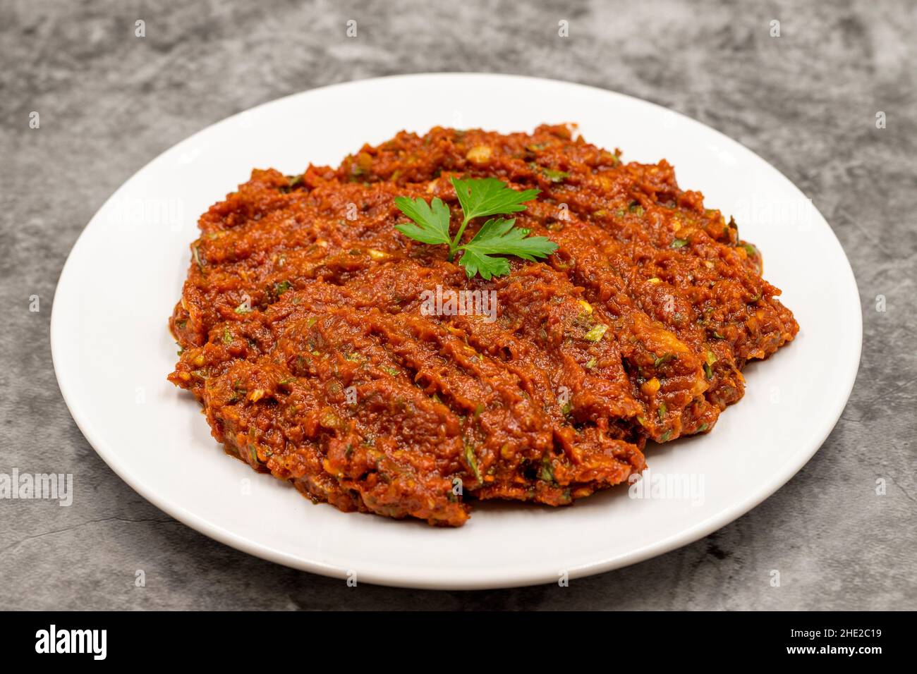 Chili paste on a dark background. spicy paste. A kind of adjika ...