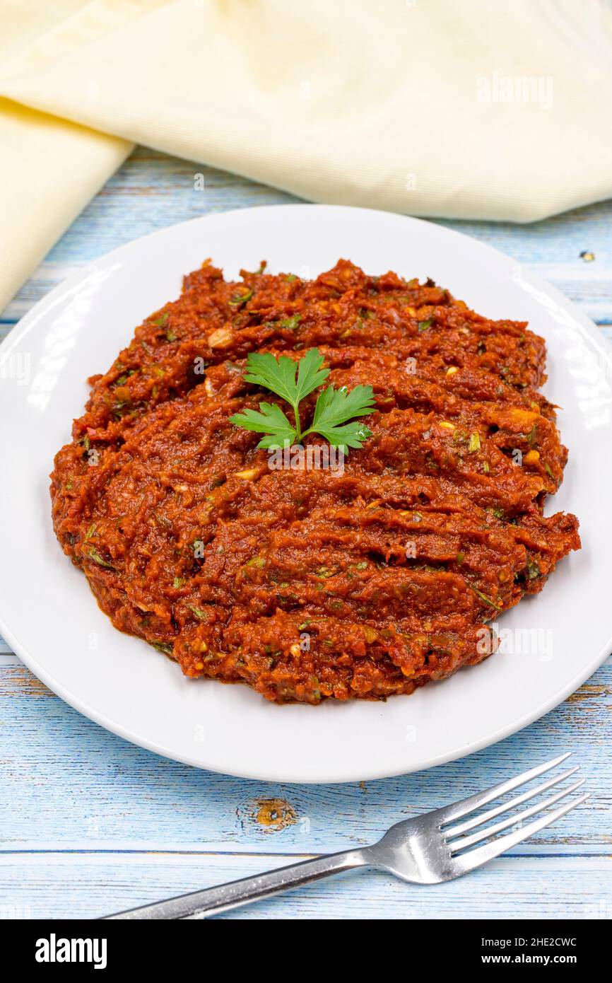 Chili paste on a wooden background. spicy paste. A kind of adjika ...