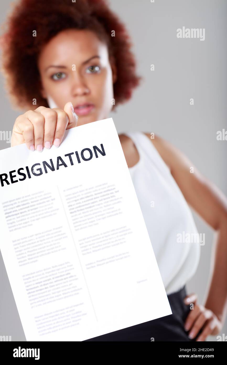 Angry determined young Black woman with Resignation sign holding it up ...