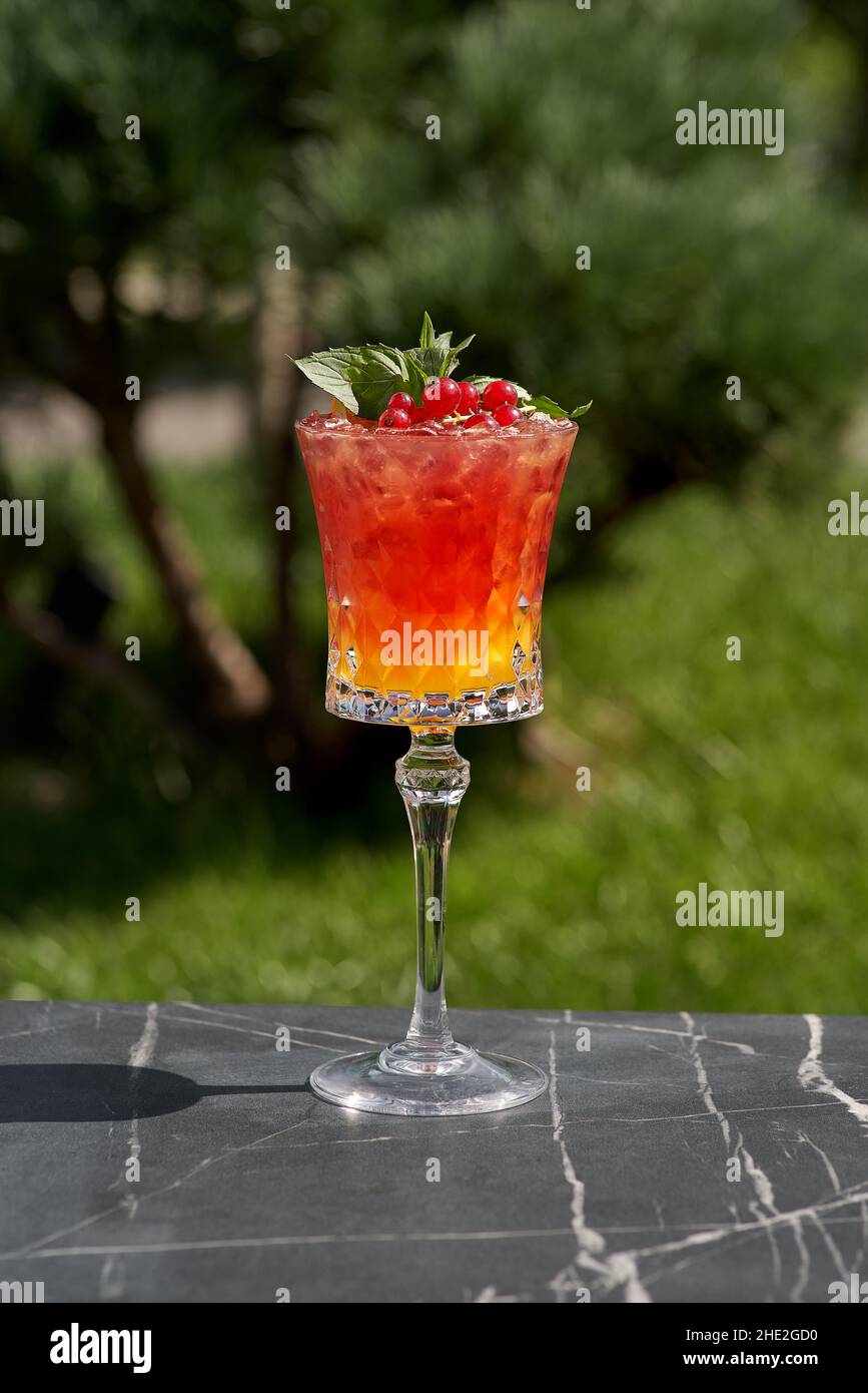 summer cocktails on the table, Yellow red cocktail Stock Photo - Alamy