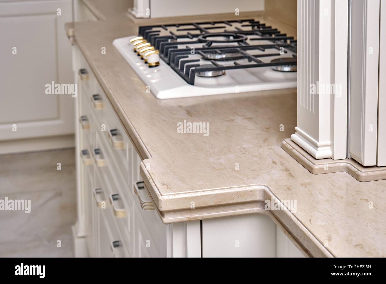 Gas stove cooktop on clean acrylic solid surface countertop in elegant ...