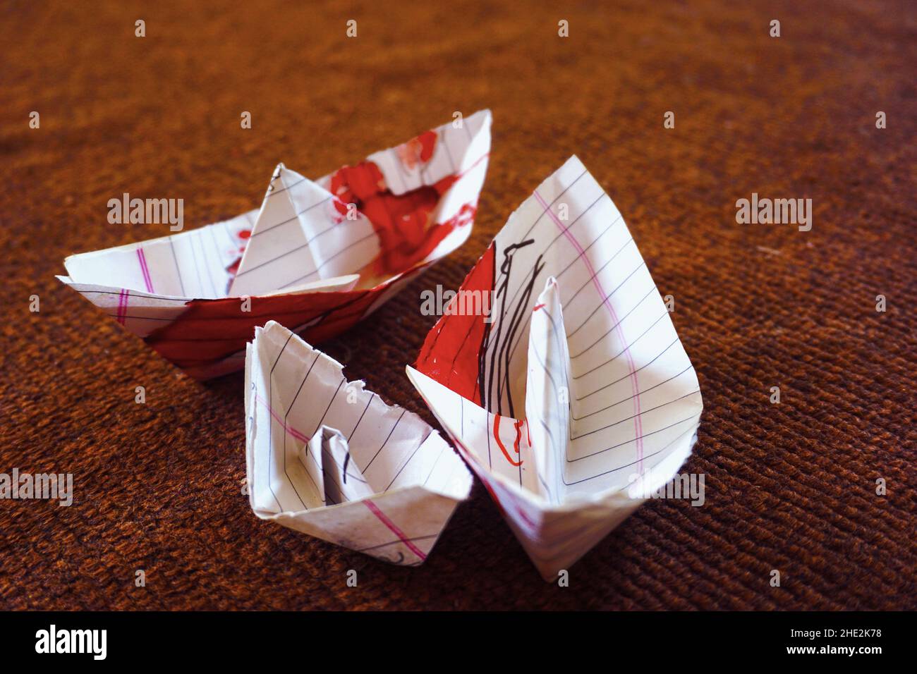 paper boats on a carpet Stock Photo - Alamy
