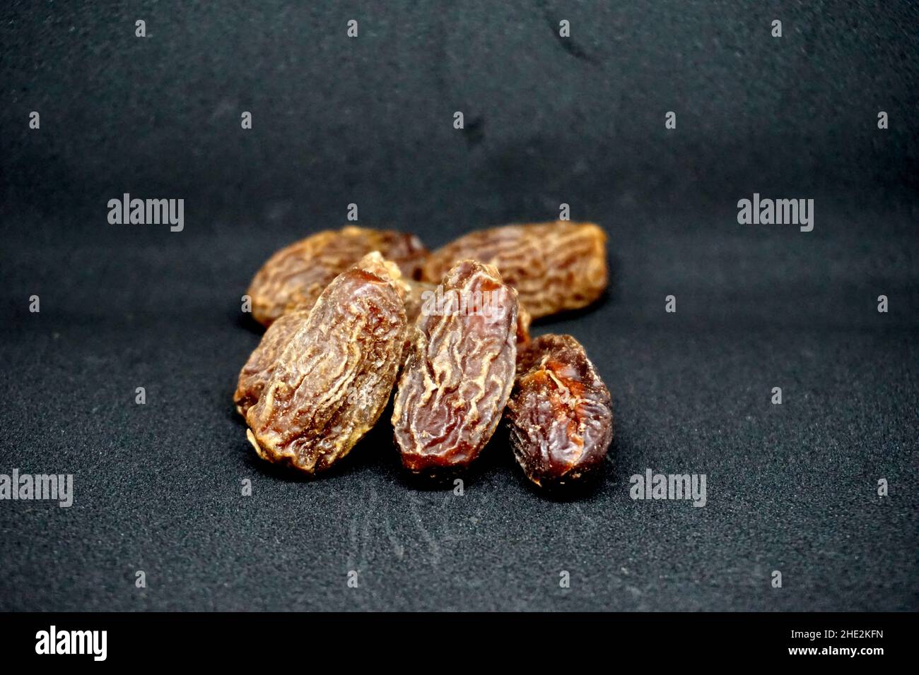 delicious dried dates with black background Stock Photo - Alamy