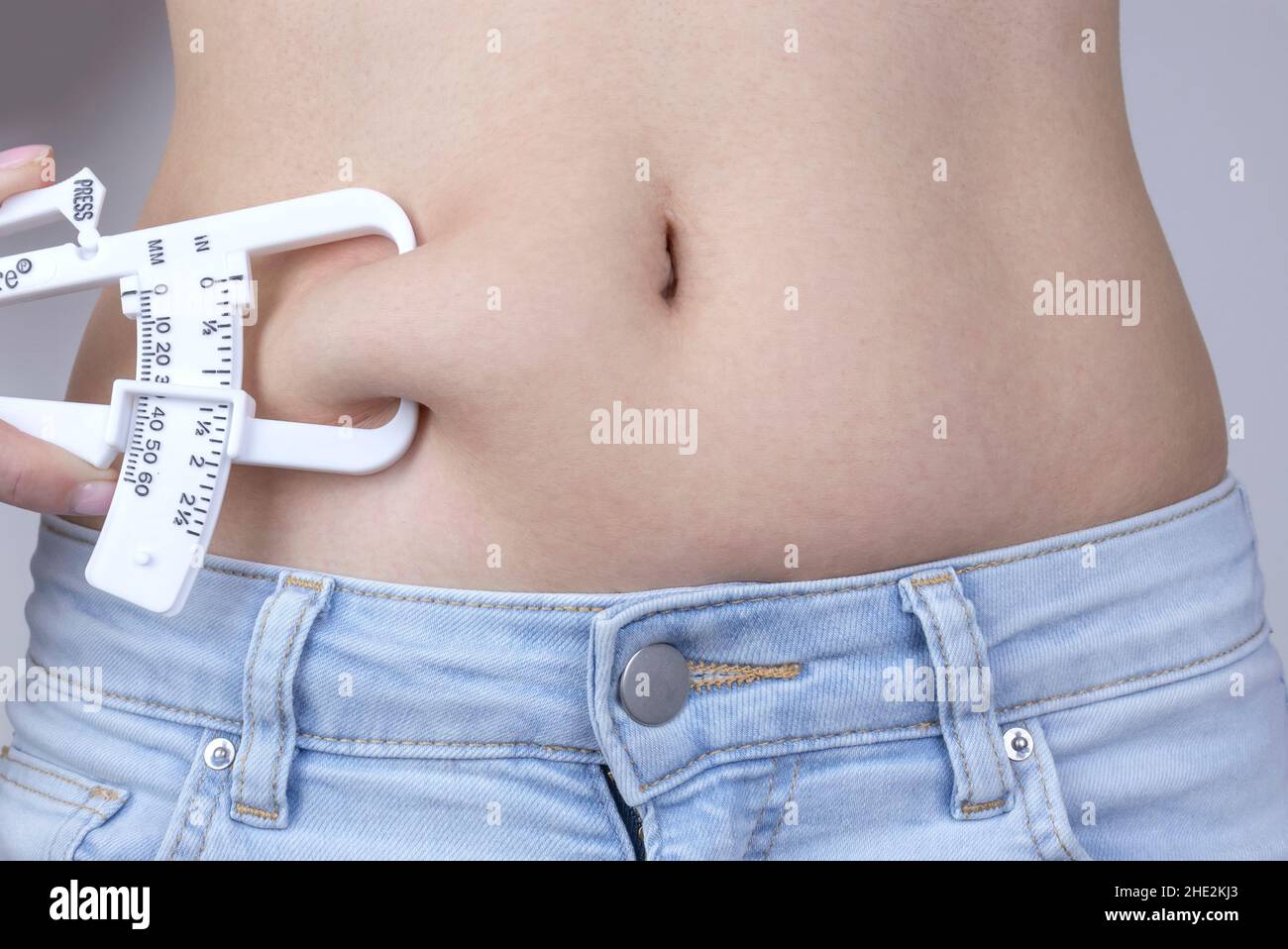 Body fat skinfold calipers, woman measuring subcutaneous percentage of ...