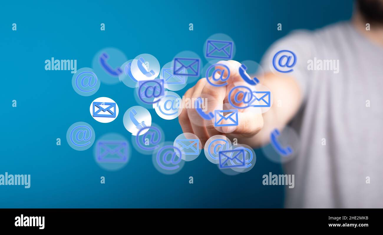 Businessman tapping on a floating network of communication icons Stock Photo - Alamy