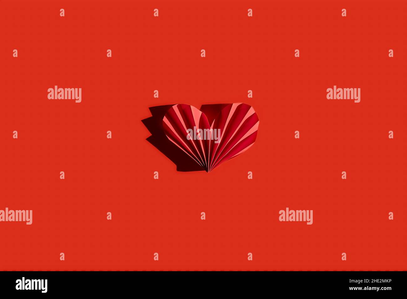 Red Paper heart on deep red background. Symbol of love for valentines ...