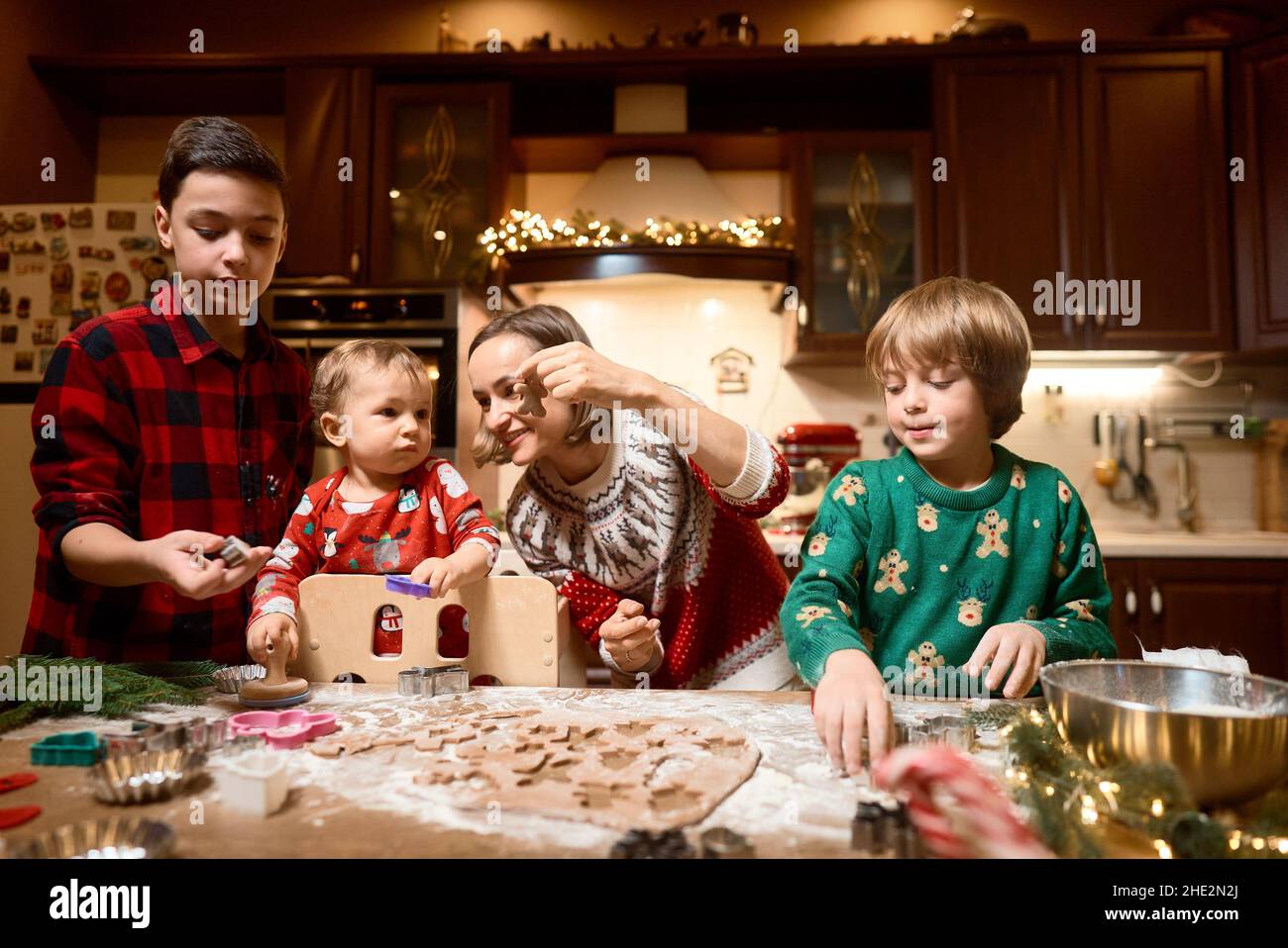 Family with three kids cooking ginger cookies. Merry Christmas, Happy ...