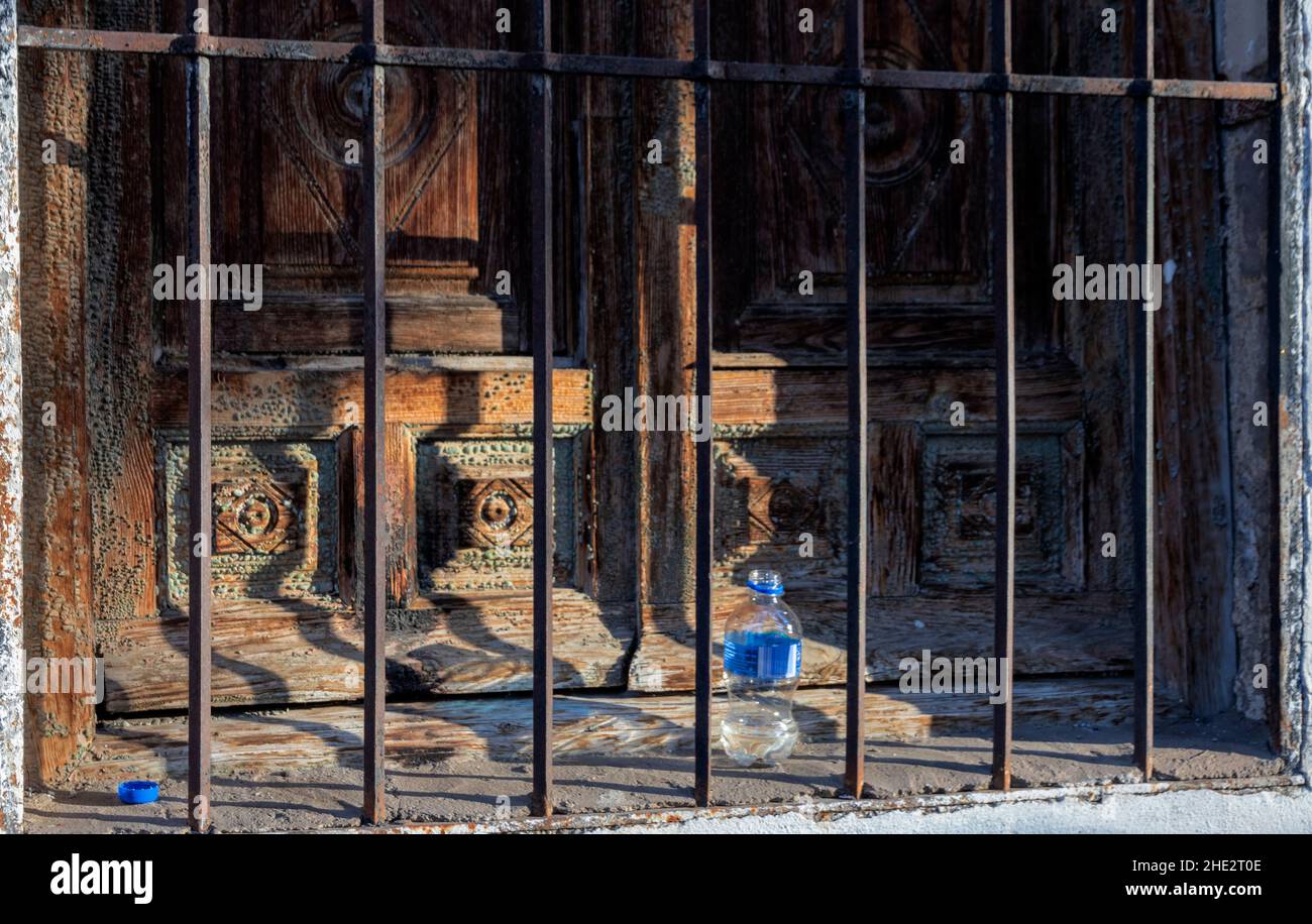 LITTER A DISCARDED PLASTIC WATER BOTTLE PLACED BESIDE A VERY OLD WOODEN ...