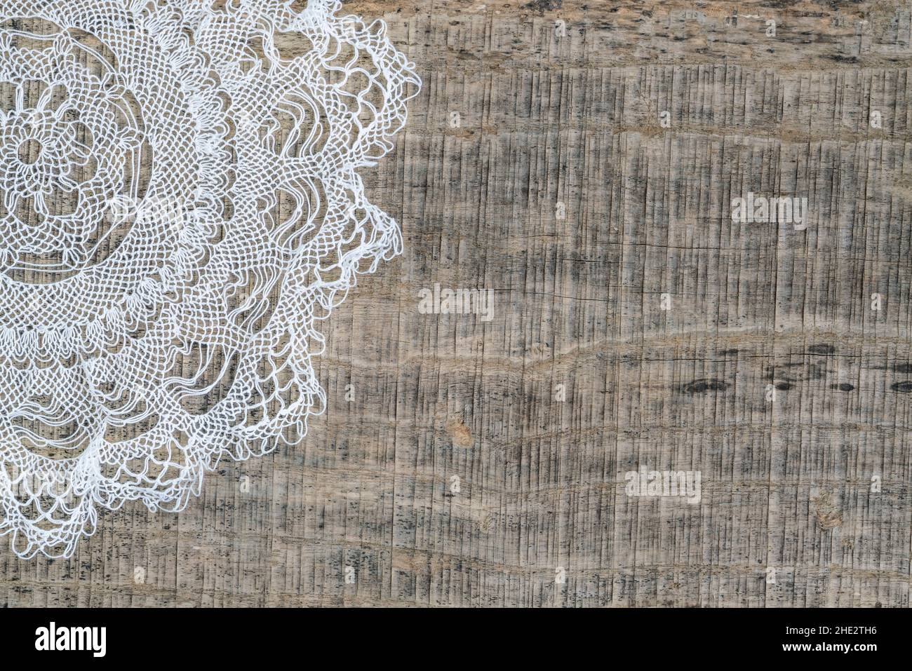 lace, piece of handcrafted white lace on wooden background or surface ...
