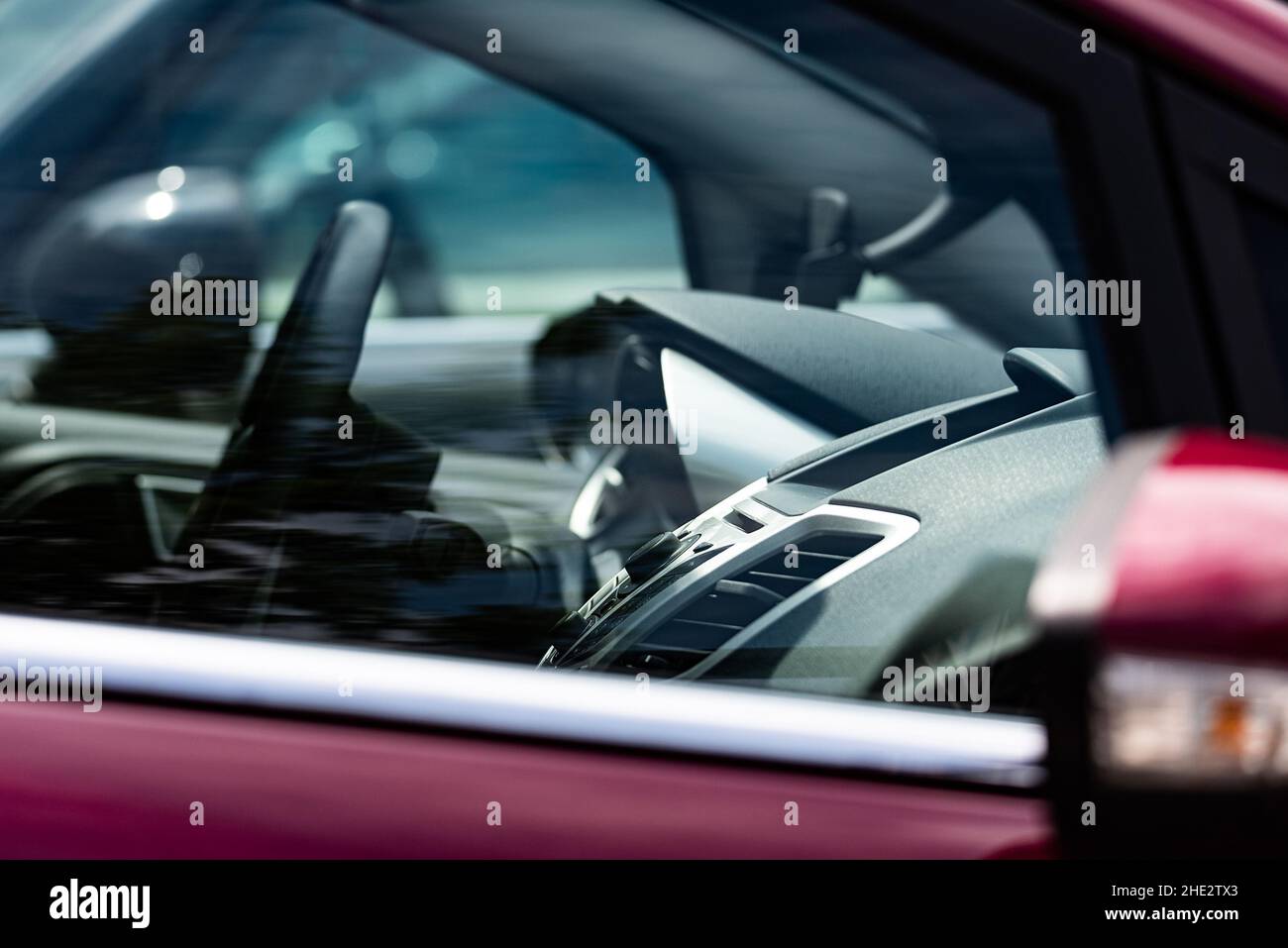 Hot car interior. Passenger car dashboard view through the side window ...