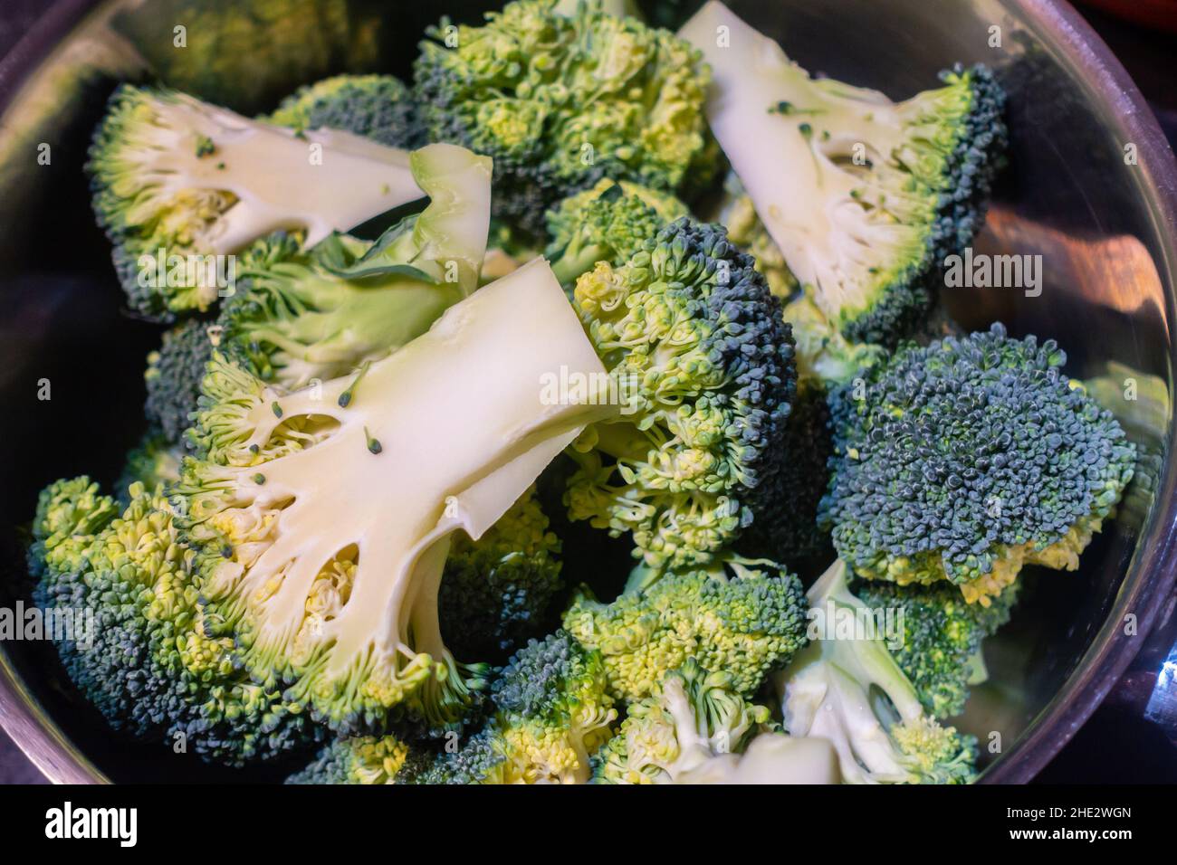 Broccoli cut up and placed in a pan ready to cook Stock Photo - Alamy