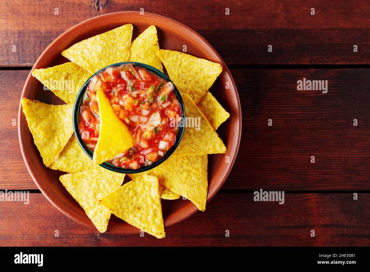 Salsa sauce and nacho chips in a clay bowl. Tortilla chips and salsa ...