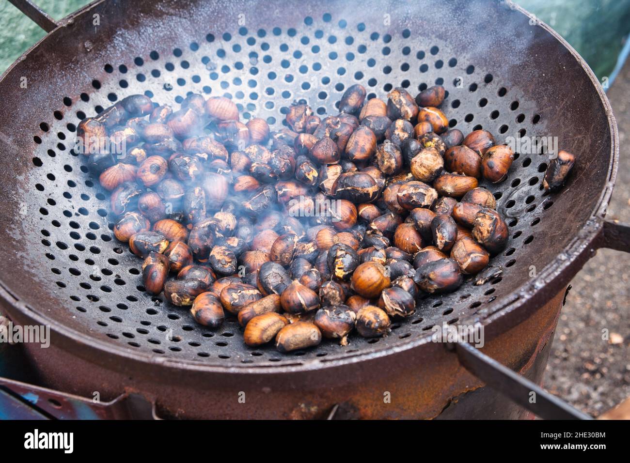 Close up of a pot roasting chestnuts Stock Photo - Alamy