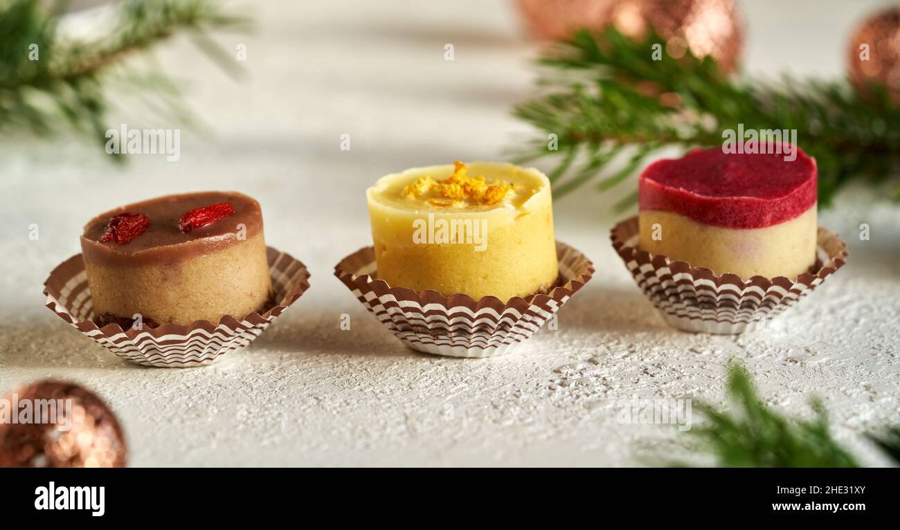 Goji, lemon and raspberry raw vegan Christmas desserts on bright ...