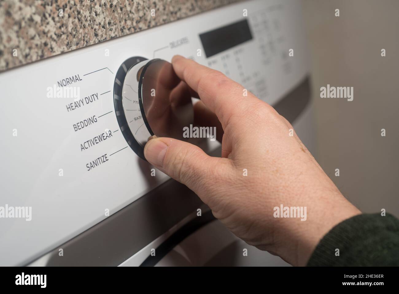 Hand turning the knob of the dryer to adjust the setting Stock Photo ...