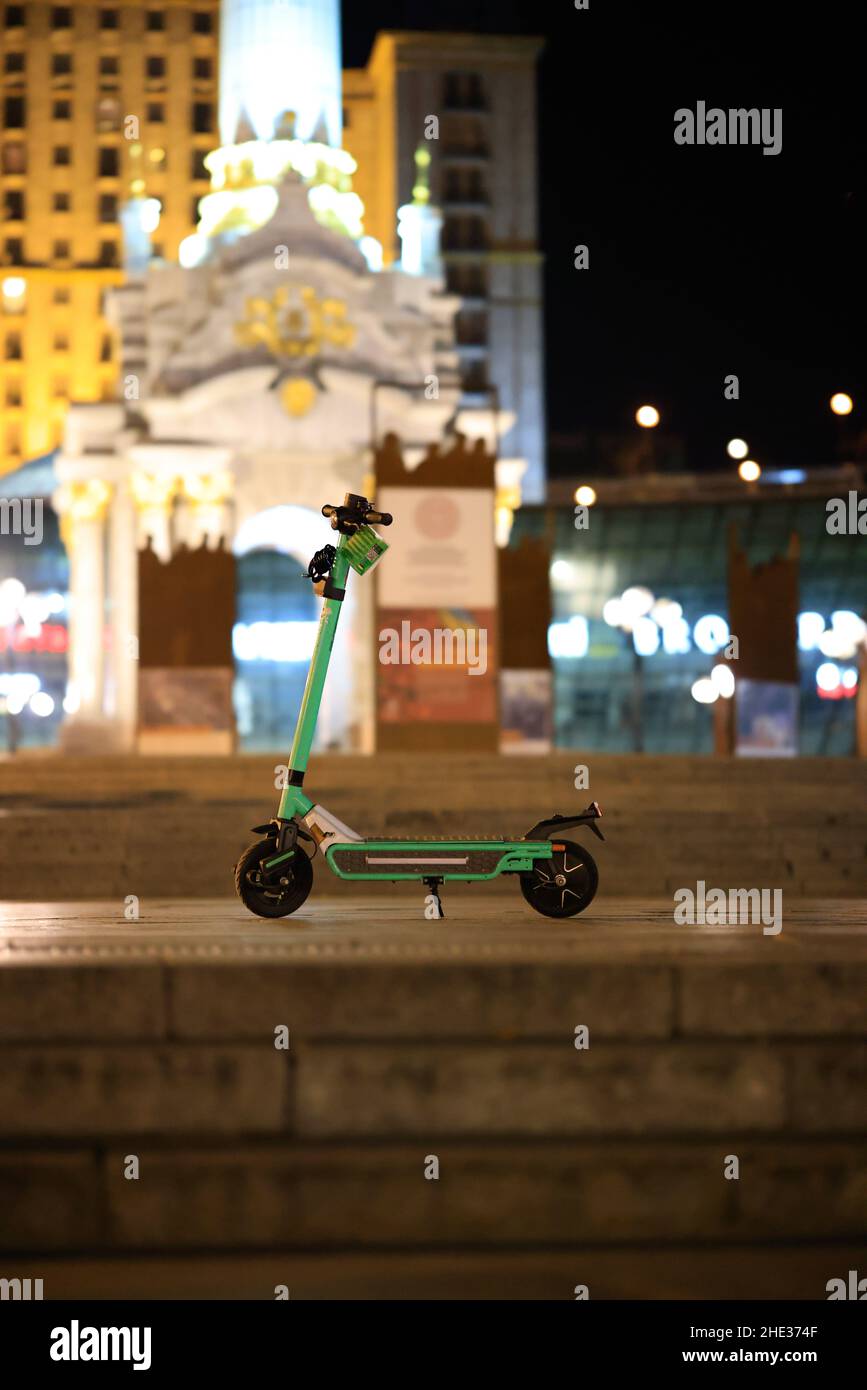 Selective focus shot of an electric scooter parked in the street at ...