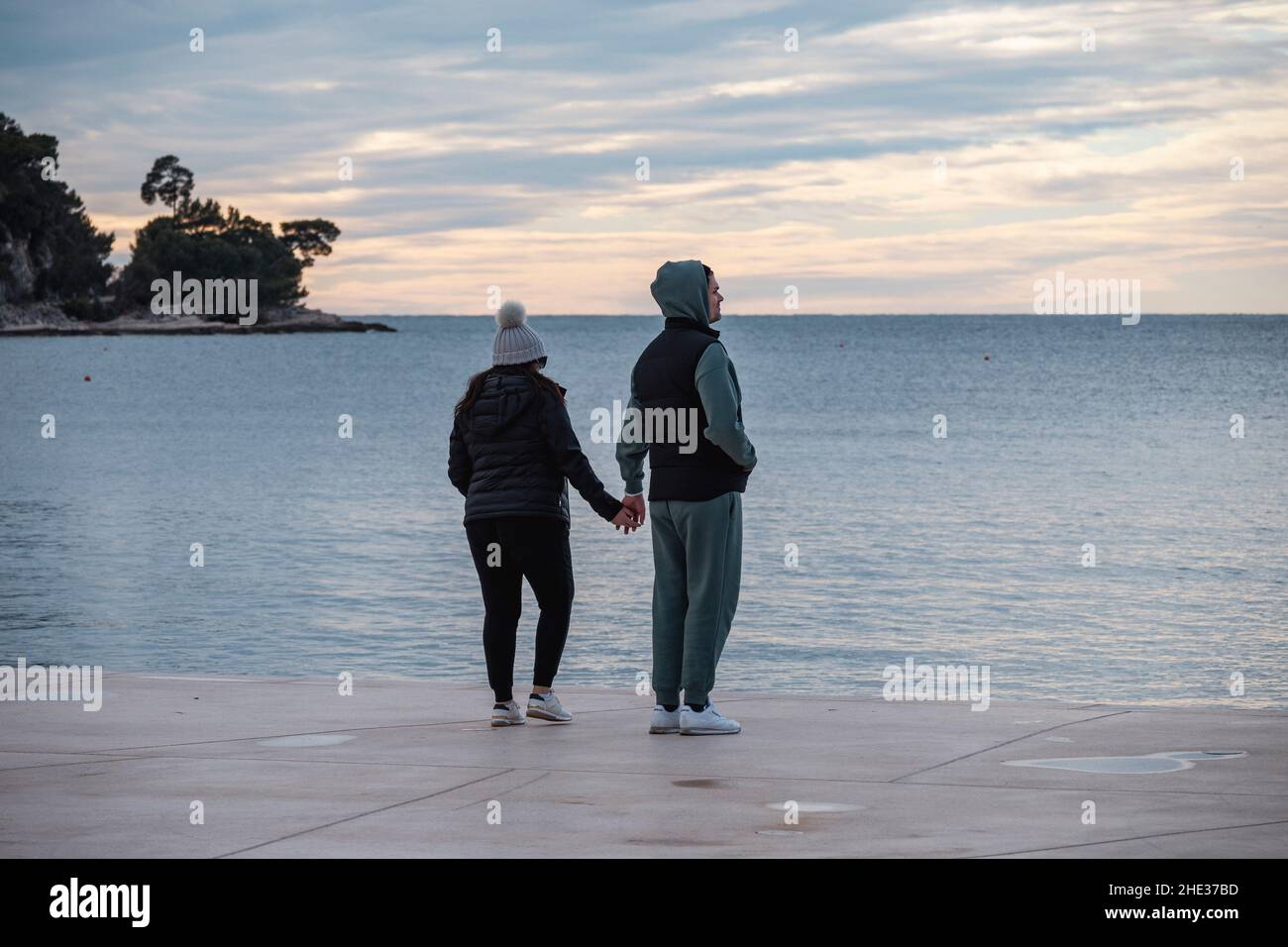 Rovinj, Croatia-January 6th, 2022: Lonely couple standing by the shore ...