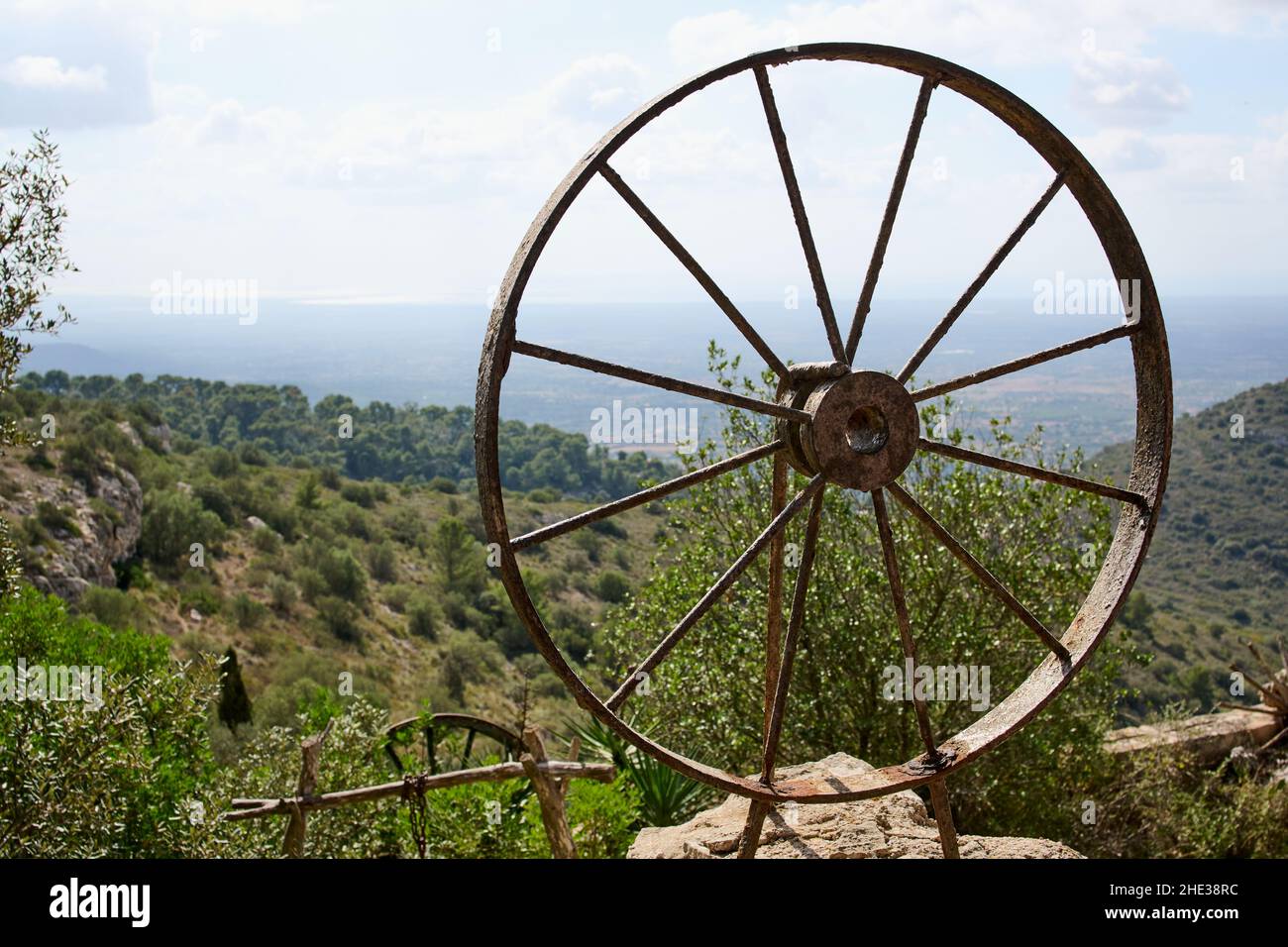 rusty wagon wheel in front of landscape in Mallorca Stock Photo - Alamy