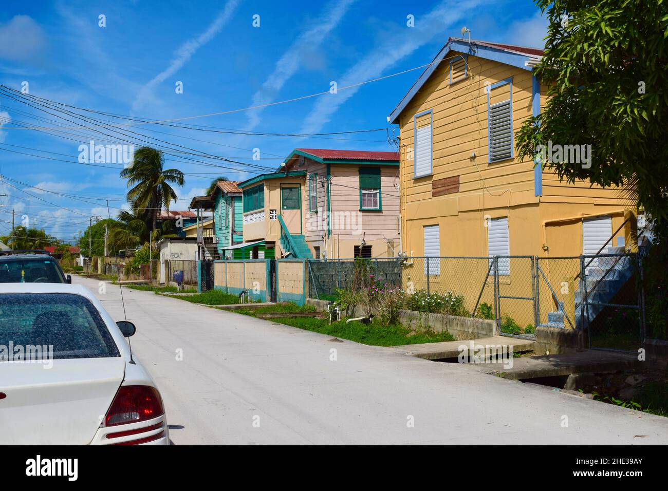 A neighborhood street with a row of colorful houses in Belize City ...