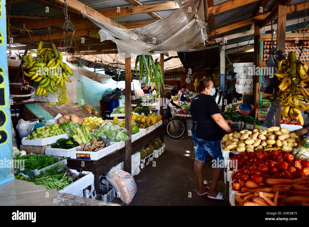 A vendor waiting to sell her produce at the Belize City market in ...