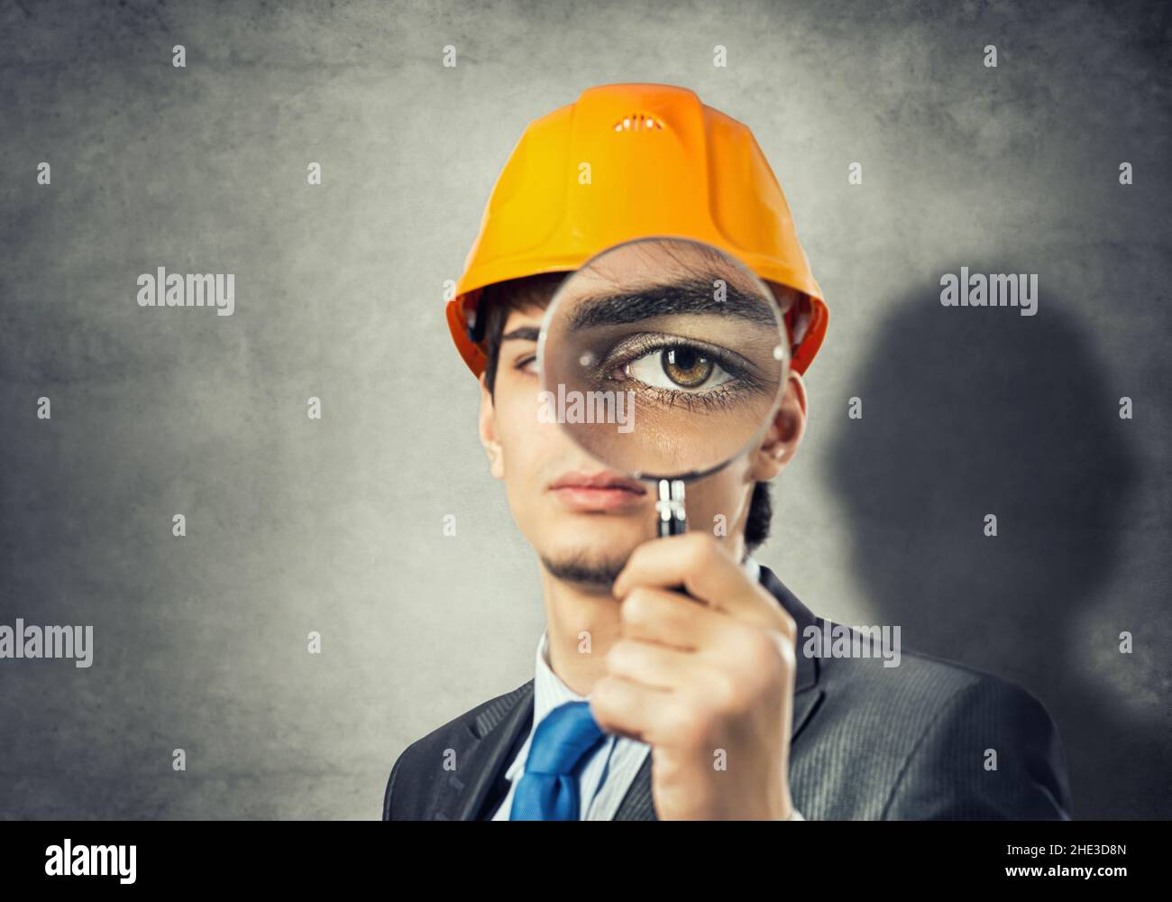 Construction man with magnifier Stock Photo - Alamy