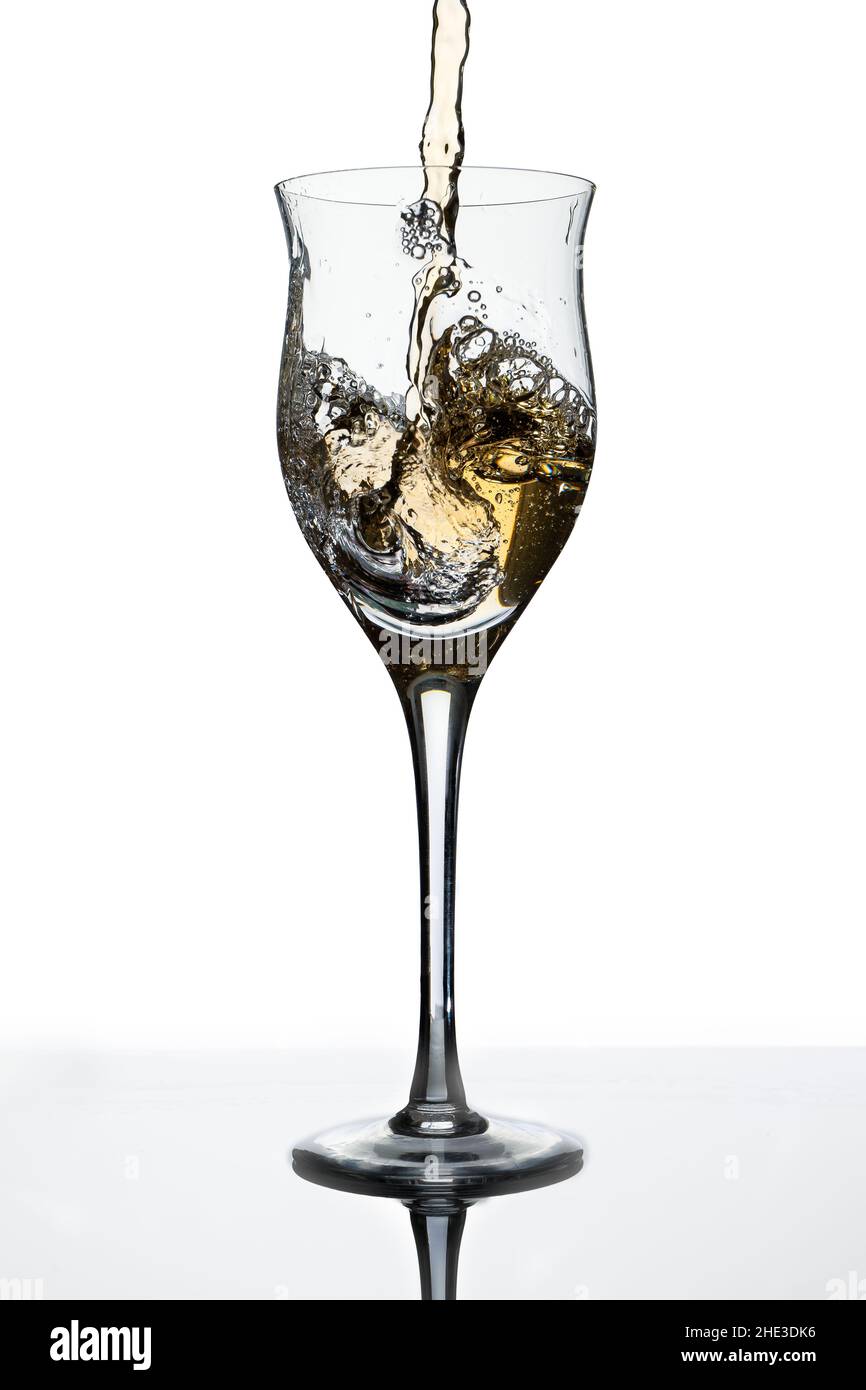 Serving a slightly tilted glass with white wine. White background ...