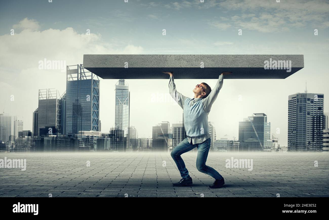 Guy lifting cement banner Stock Photo - Alamy