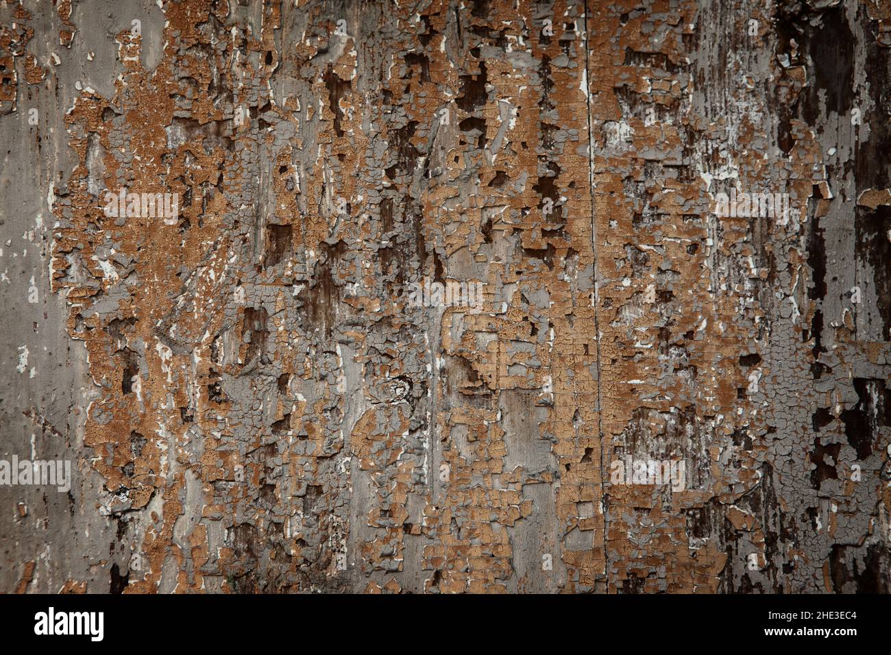 Abstract faded yellow texture with cracks and peeling paint on a wooden ...