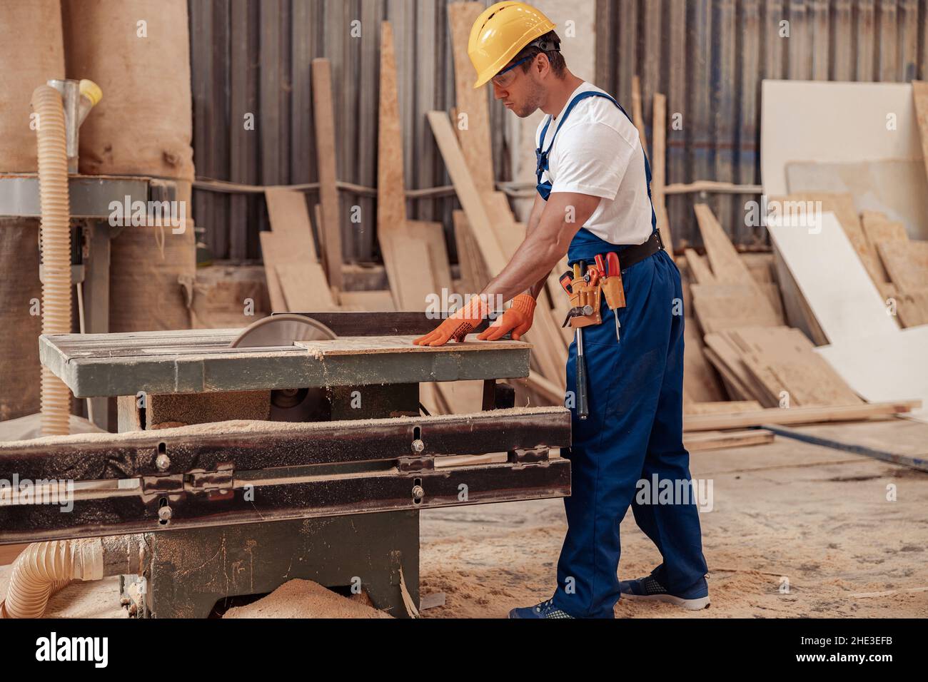 Male worker using woodworking equipment in workshop Stock Photo - Alamy