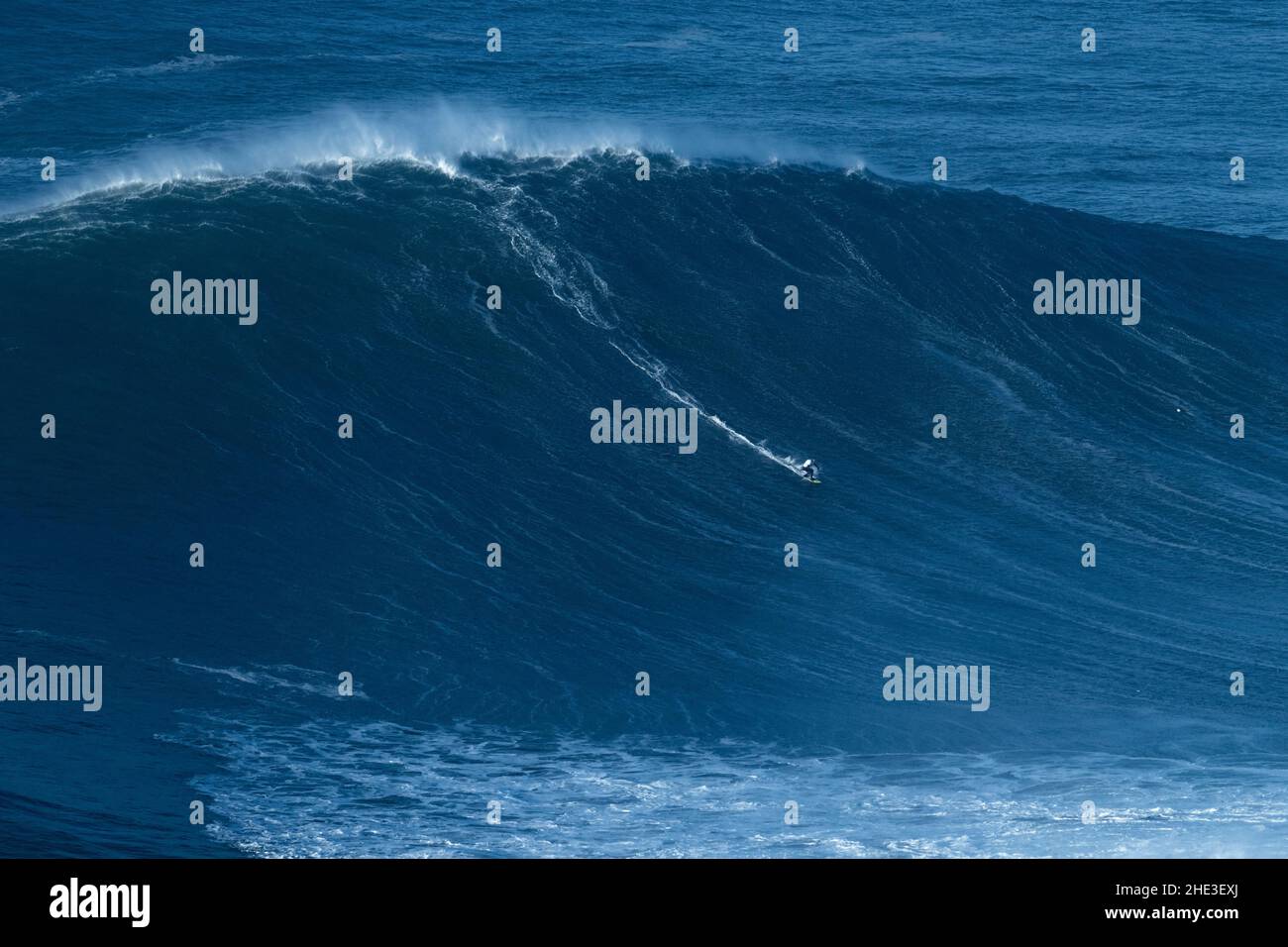 A surfer seen riding a big wave at Praia do Norte Beach in Nazare.First ...