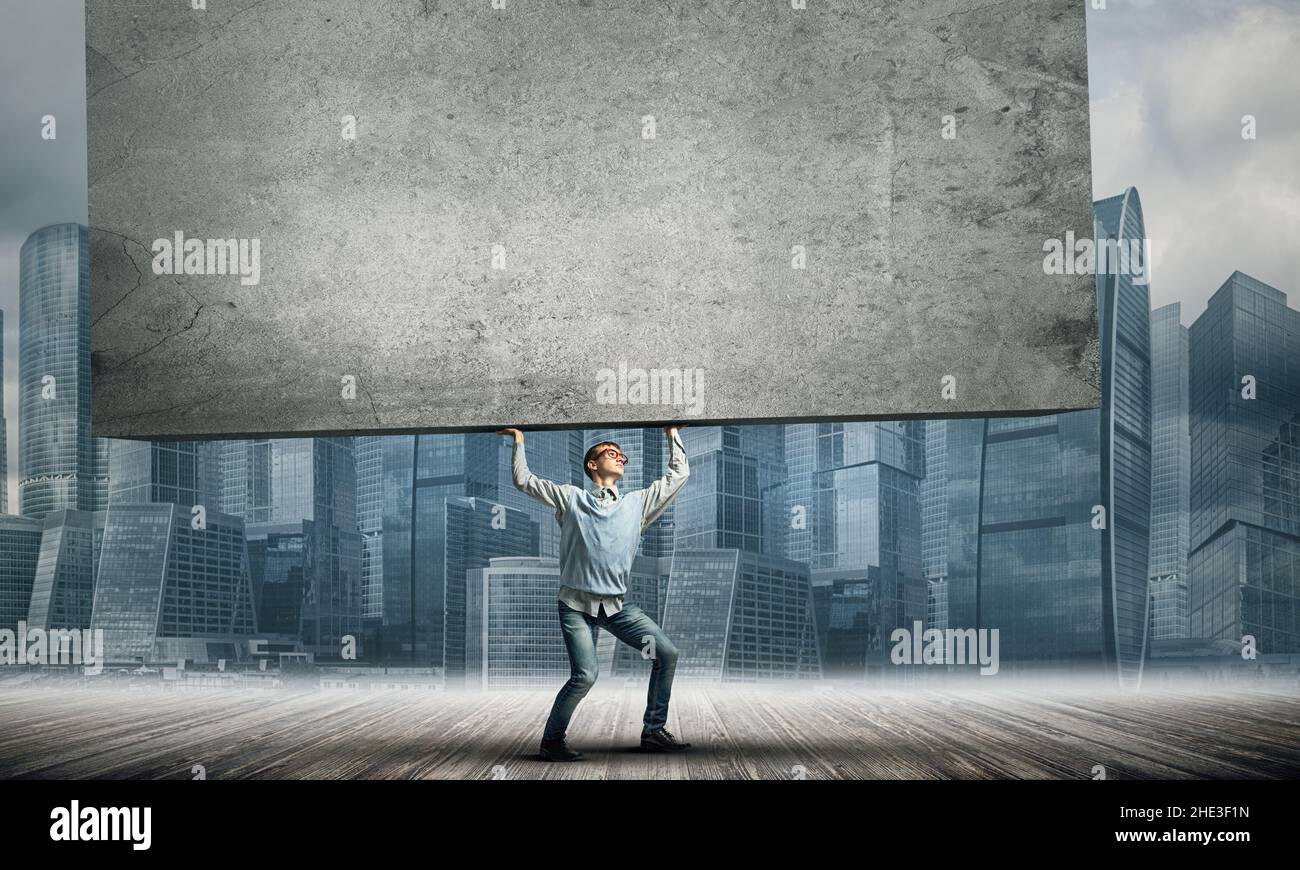 Guy lifting cement banner Stock Photo - Alamy