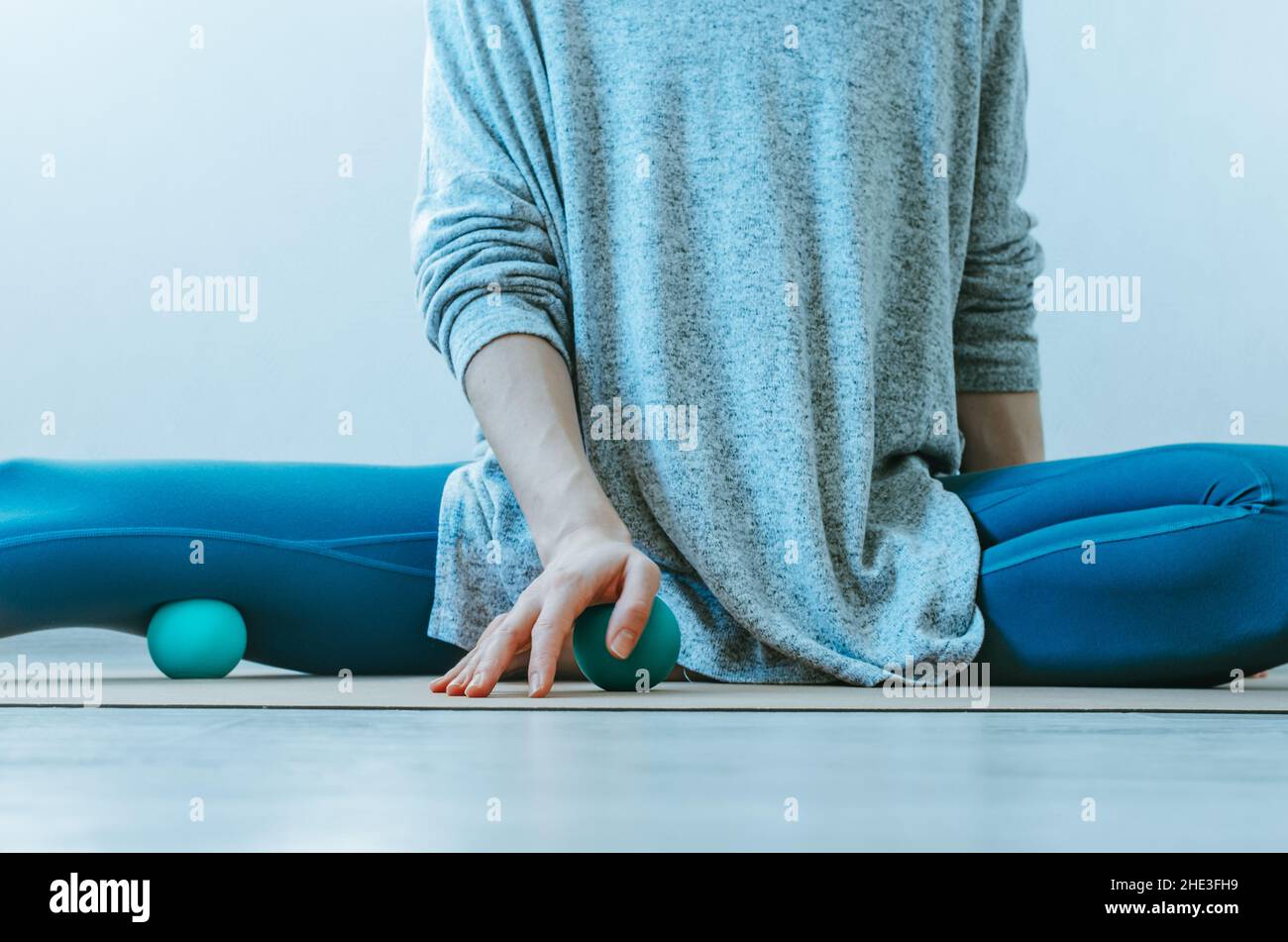 Person doing yin yoga and myofascial release on base of palm and ...